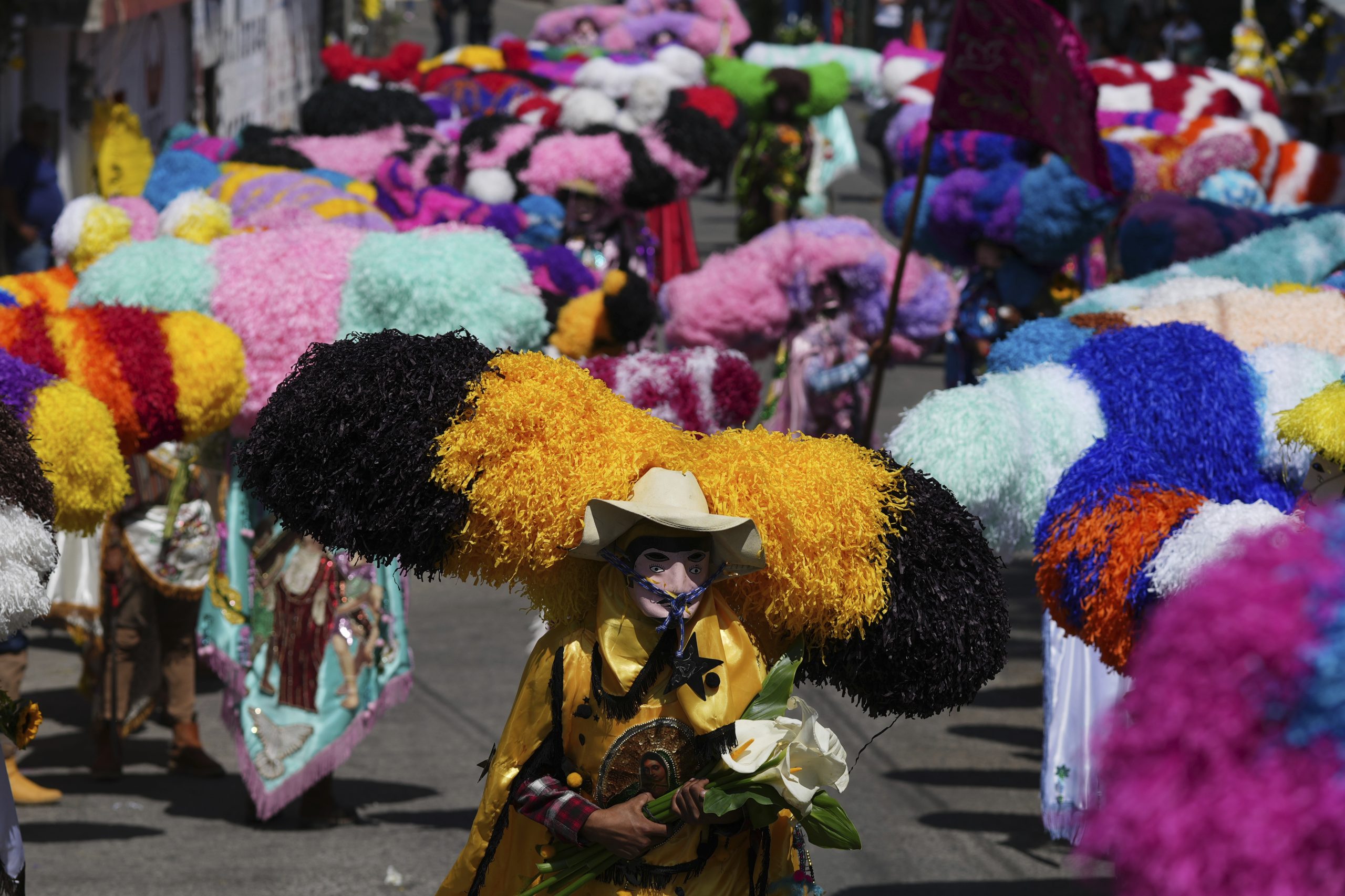 Easter is celebrated with giant caterpillar-like hats and flames in ...